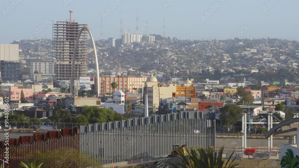 The towering structures of Tijuana rise behind the Mexico-U.S. border ...