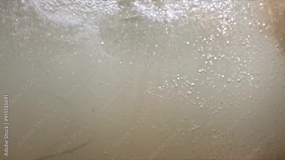 Waves on shore seen underwater. Camera goes below and above water ...