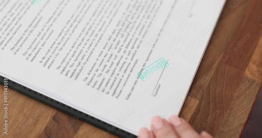 Office manager presses Approved stamp on commercial document. Female ...