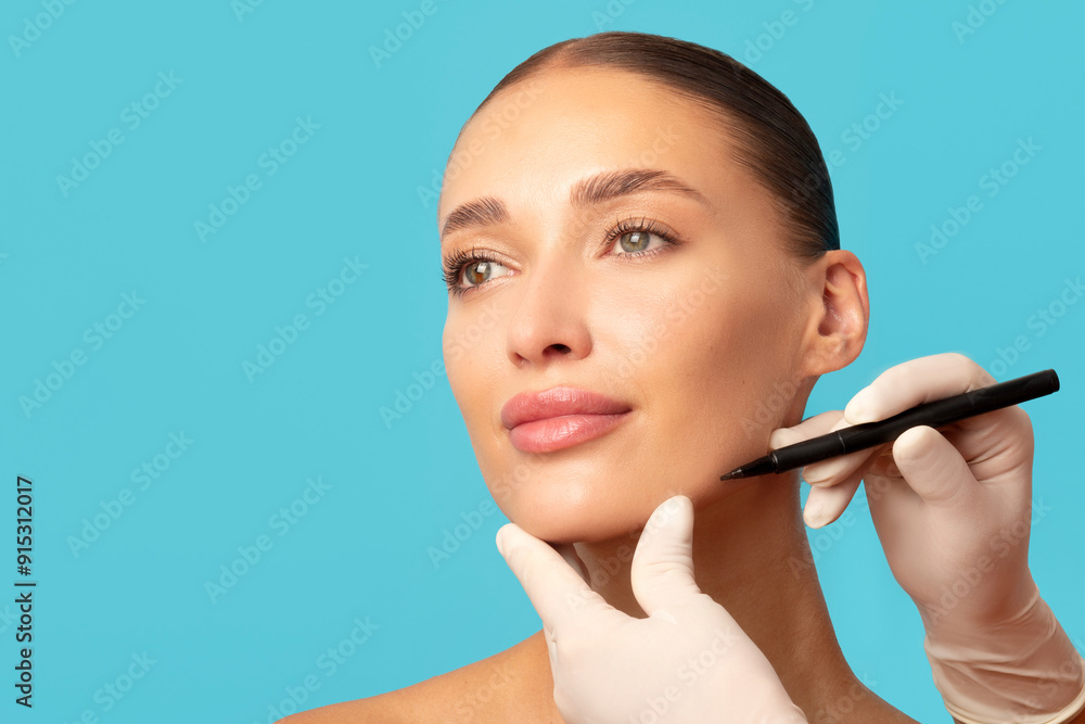 Plastic surgeon drawing contours with black pen of woman face before ...