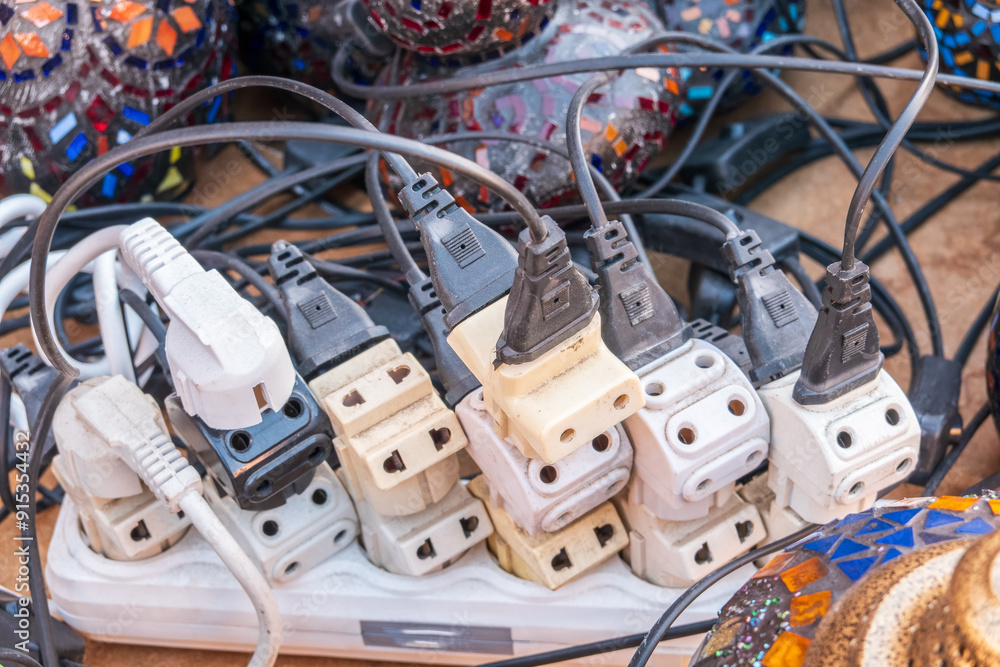 Old and damaged electric adapter power plug has many appliances are ...