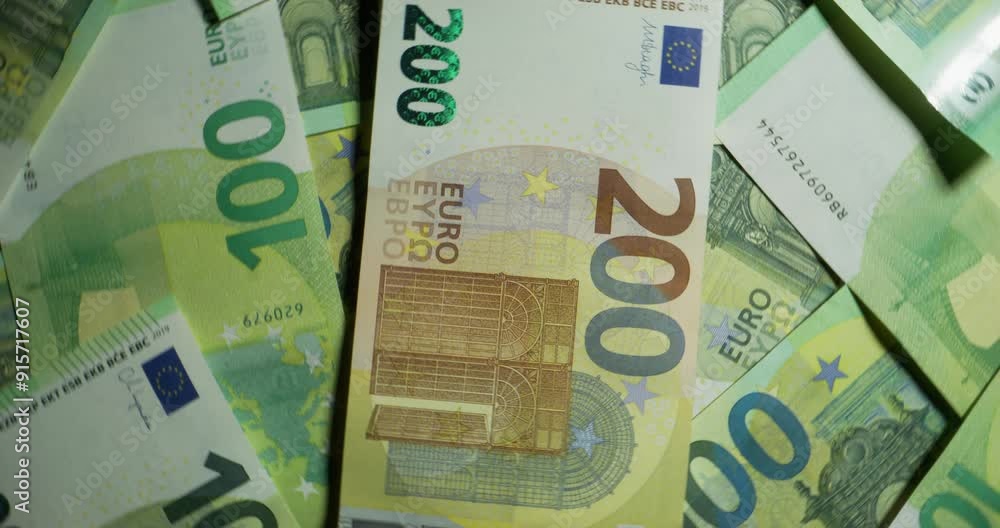 One hundred euro bills are randomly placed on the table. The 200 euro ...