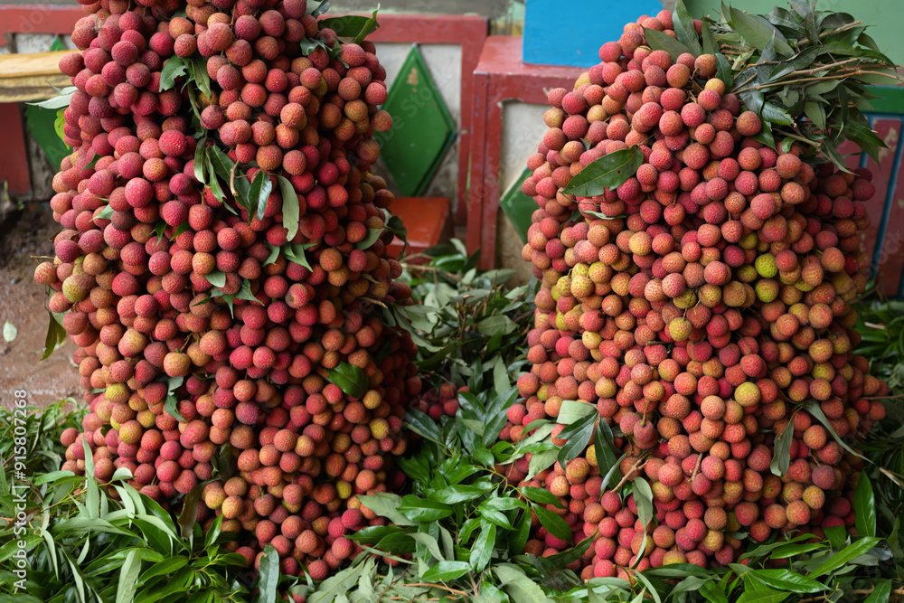 Freshly picked ripe lychees, ready for sale at the market. Vibrant ...