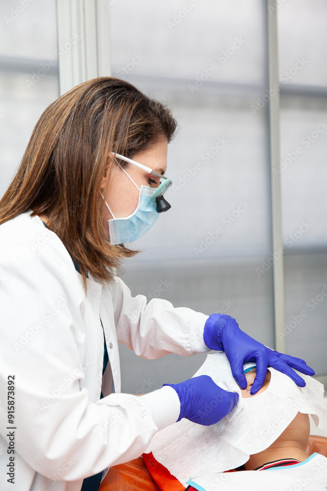 Skin lesion removal procedure. Dermatologist carrying out a removal of ...