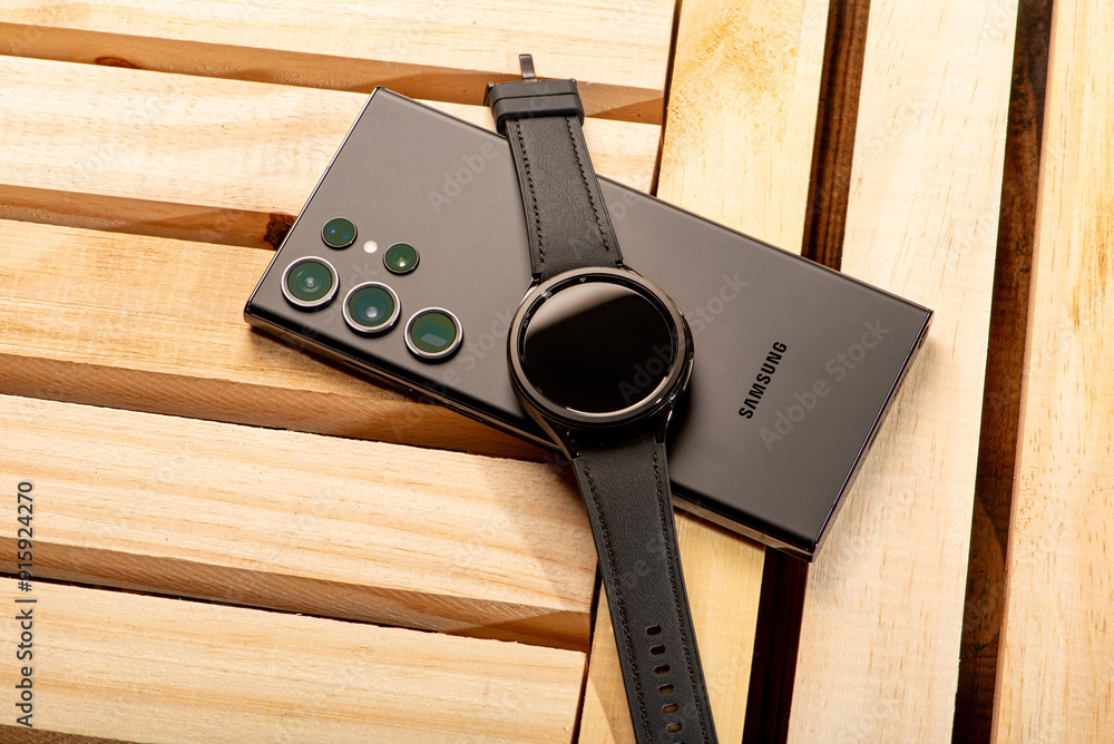 Samsung Galaxy Watch6 Classic smartwatch, S23 ultra cell phone on ...