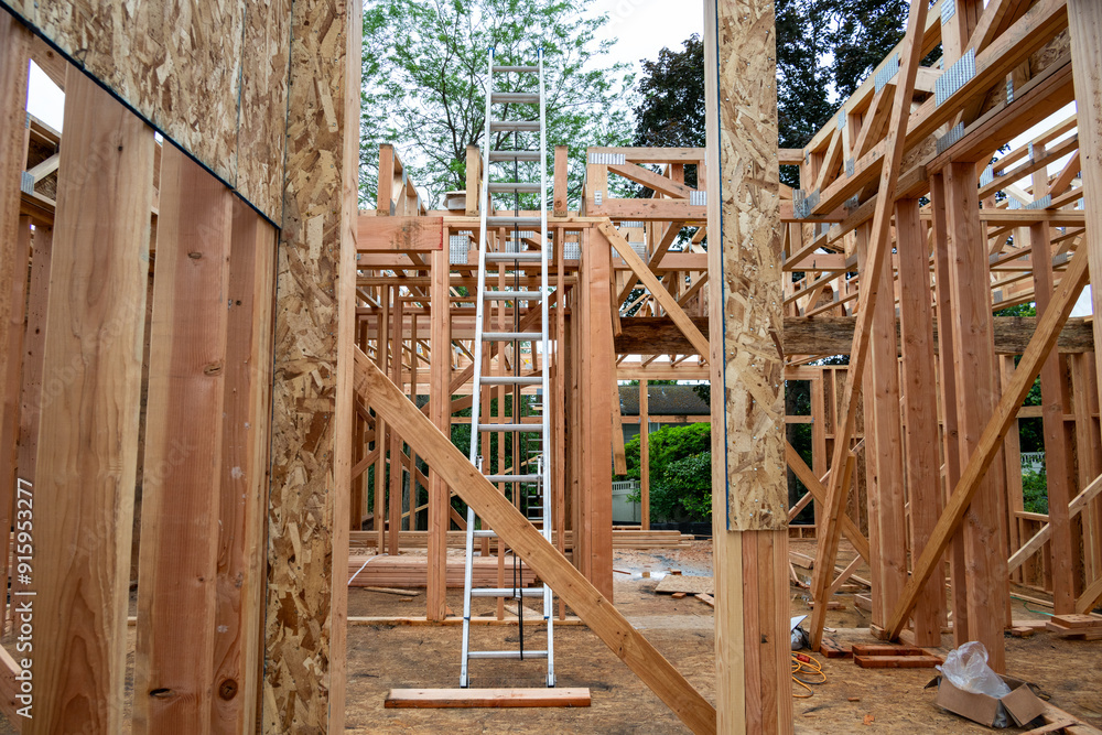 Interior new house construction at wood framing stage, aluminum ...
