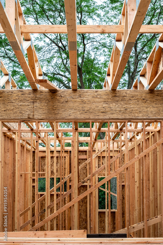 Interior new house construction at wood framing stage, looking up at ...