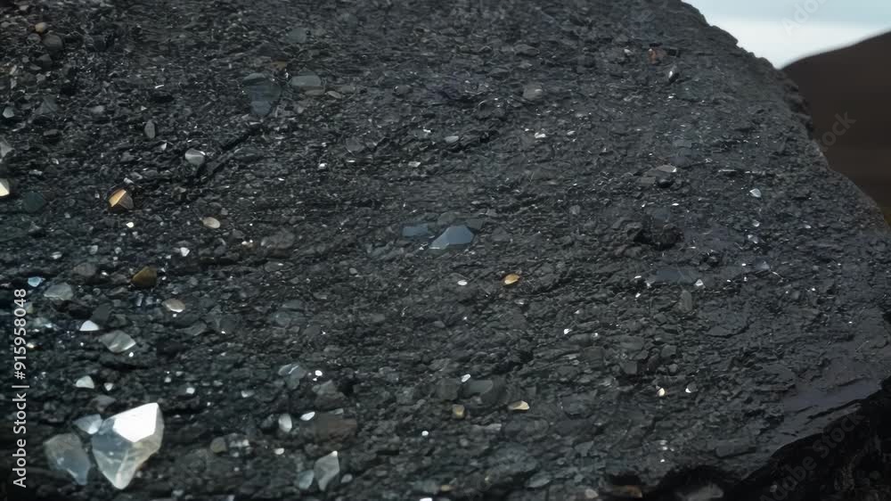 As the camera focuses on a large volcanic rock we see its rough and ...