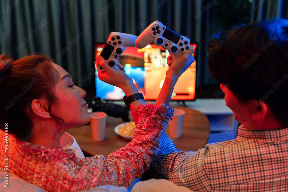 Couple gamer with hands cross of joystick playing fighting competition ...