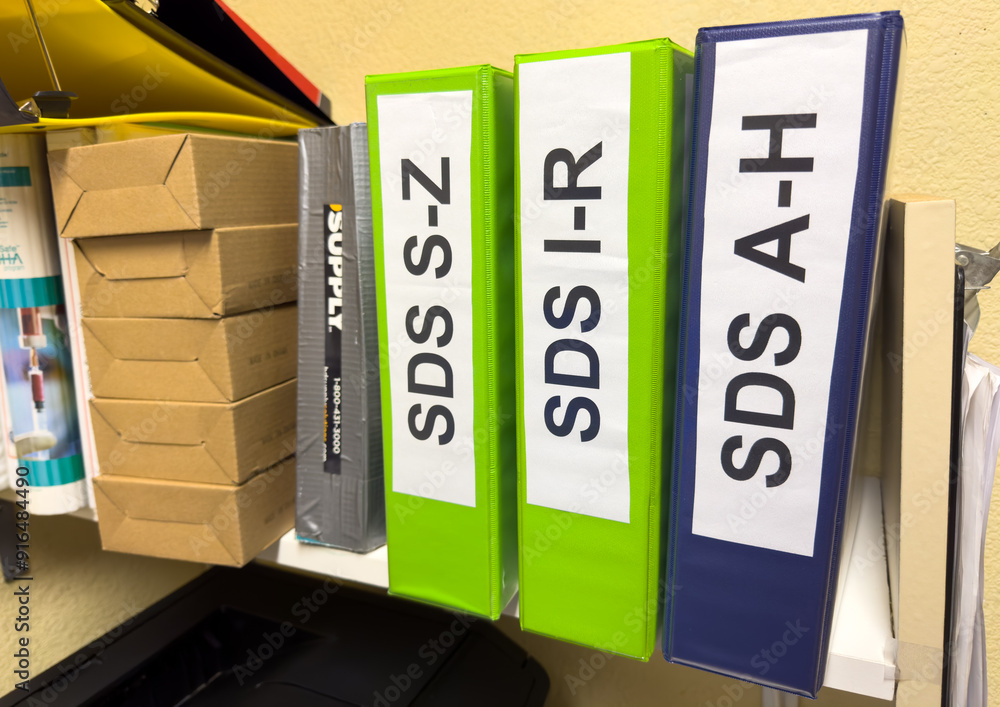 SDS binders on a shelf in an OSHA compliant workplace. Stock Photo ...
