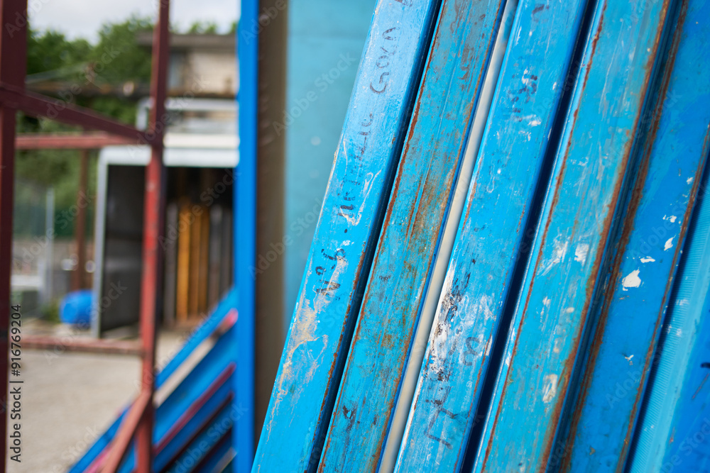 Silk screen printing screens stored in a outdoors in a metal rack ready ...