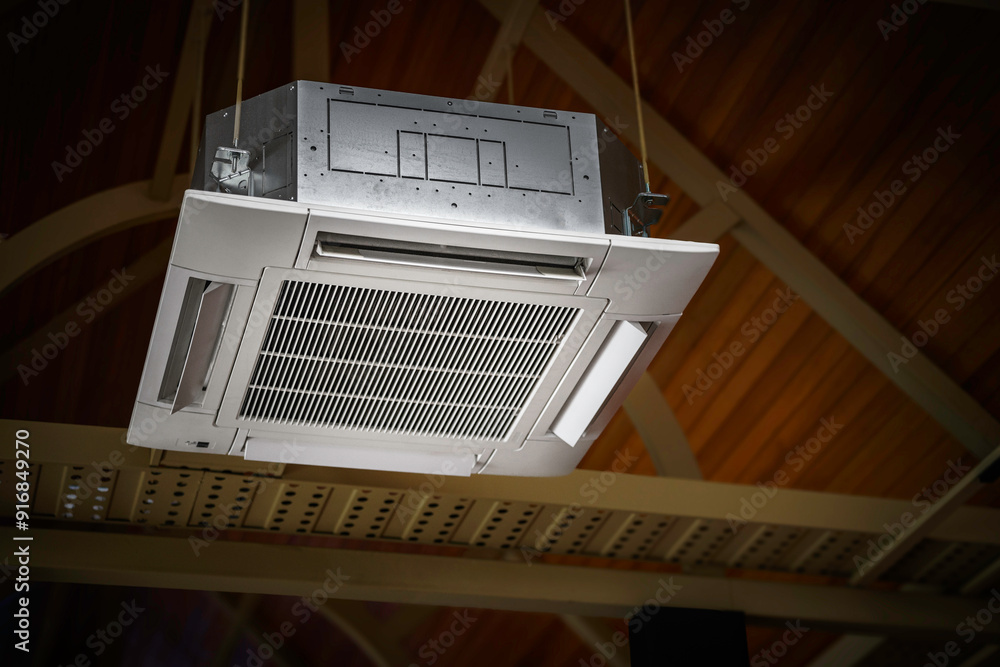 Ceiling-mounted air conditioner with four-way distribution Stock Photo ...