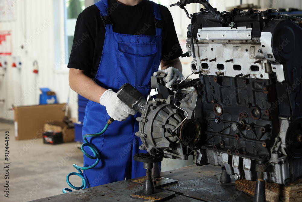 Auto mechanic fixing motor at automobile repair shop, closeup. Car ...