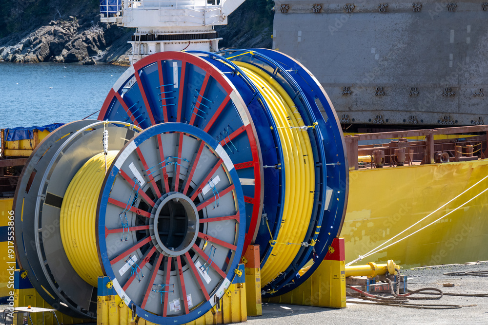 Bulk sub-sea industrial glass fiber optic cable on a metal spool on a ...
