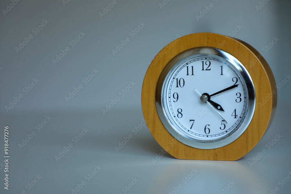 Desktop classic yellow clock close-up on a white background. Never ...