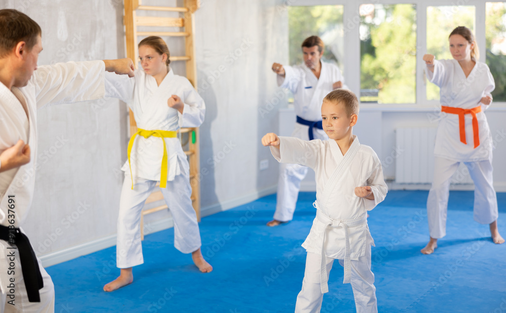 Boy and his family, dressed in kimonos, stand in row during class ...