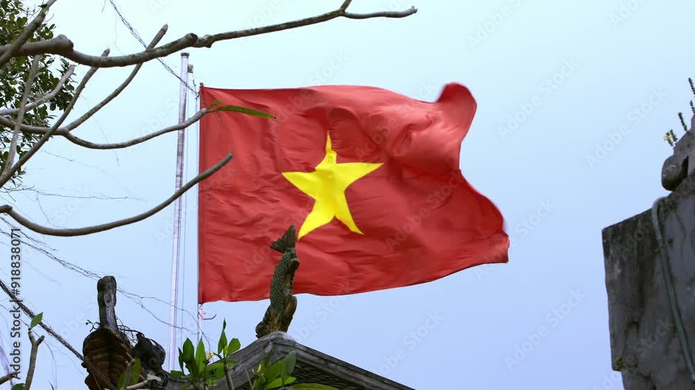 Slowmotion of a flag of Vietnam with red color and a yellow star at its ...