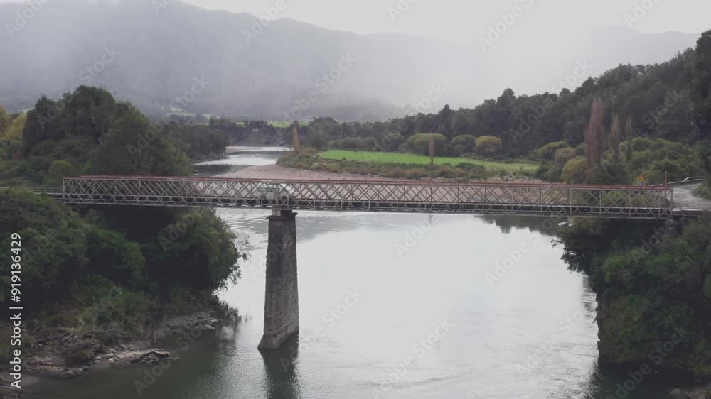 Aerial drone shot of a camper van crossing the Iron Bridge over the ...