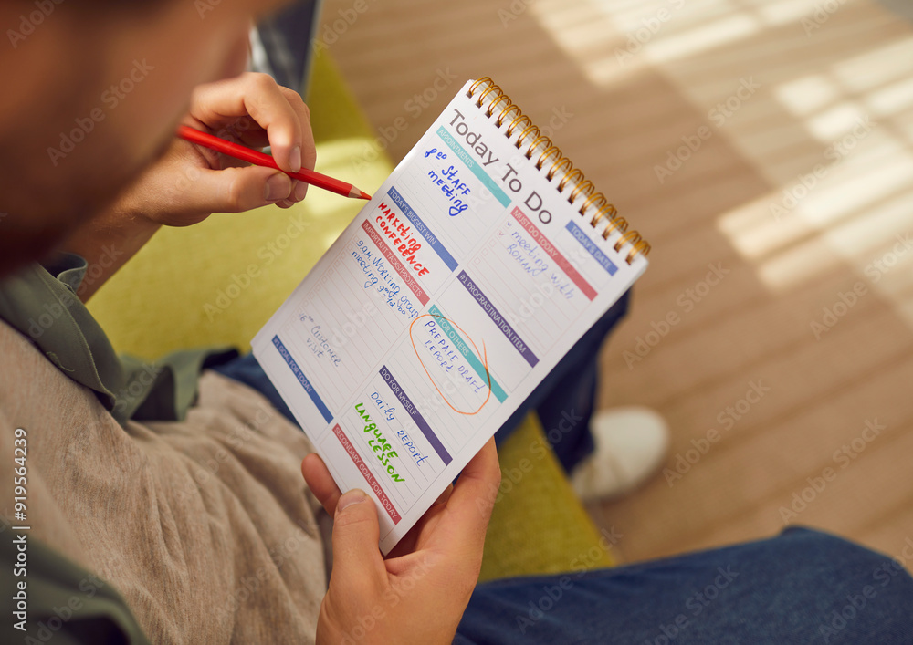 Busy man writing to do list in notepad. Man holding pencil and ...
