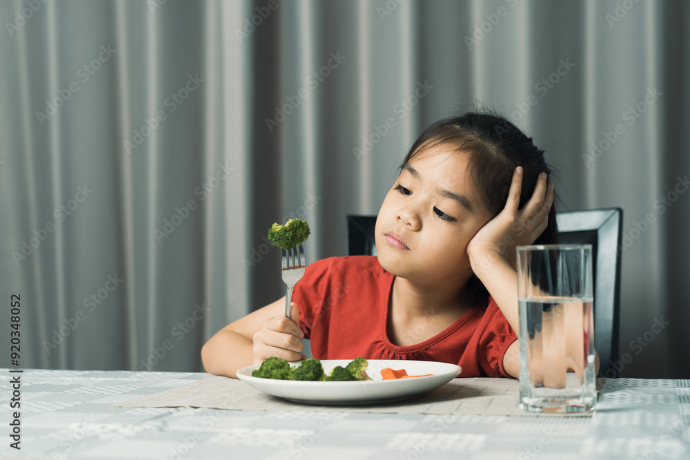 Little cute kid girl refusing to eat healthy vegetables. Children do ...
