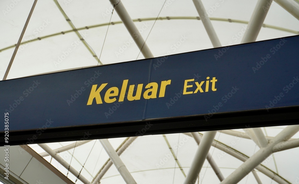 Exit sign board in horizontal train station indoor ceiling structure ...