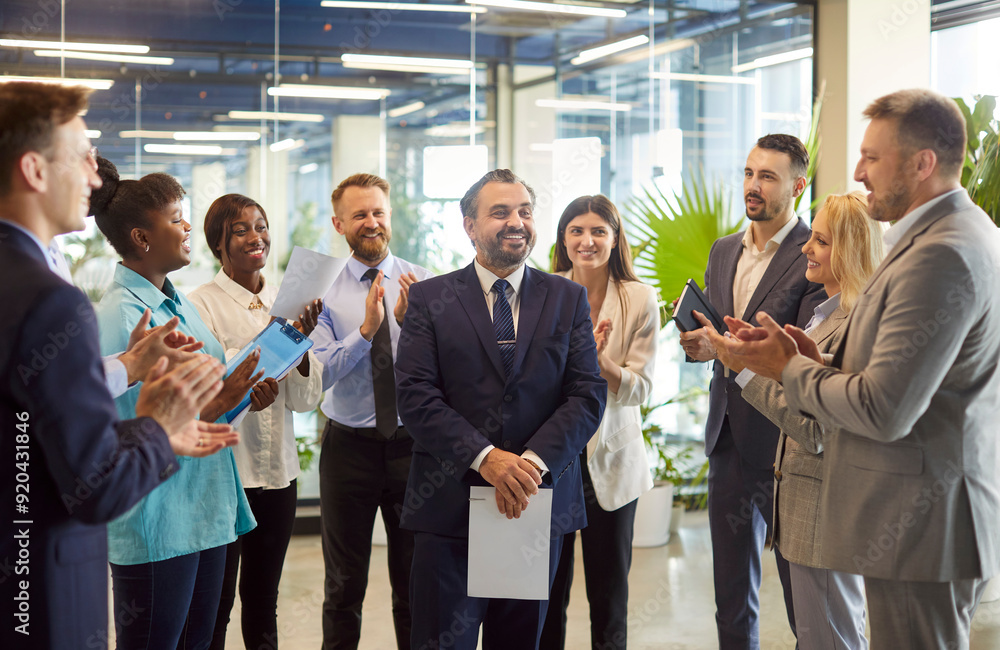 Group of company employees congratulating their happy male colleague on ...