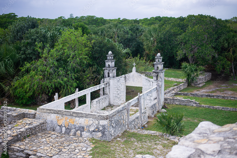 catholic church built next to the ruins of complex of mayan pyramids ...