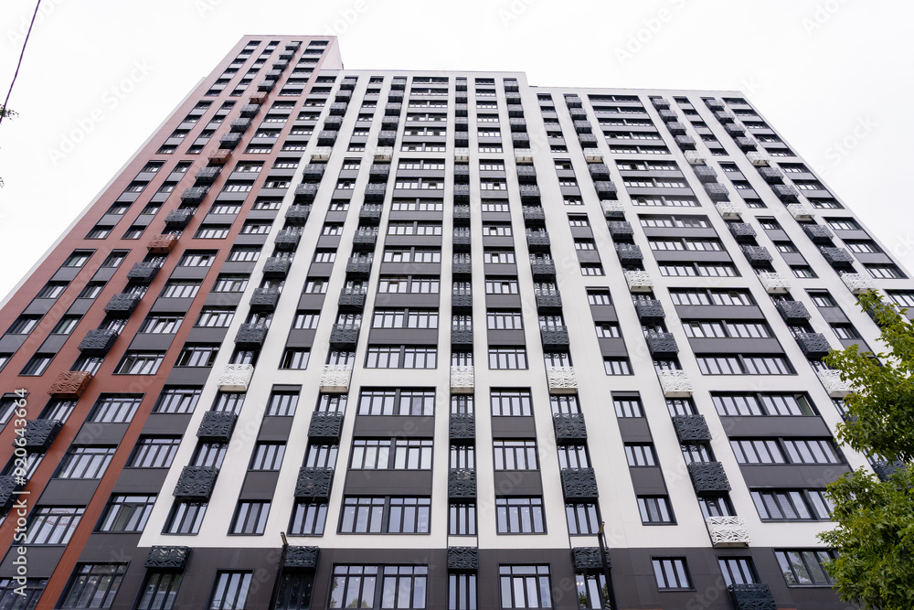 As I gaze at this tall and impressive building featuring gleaming ...