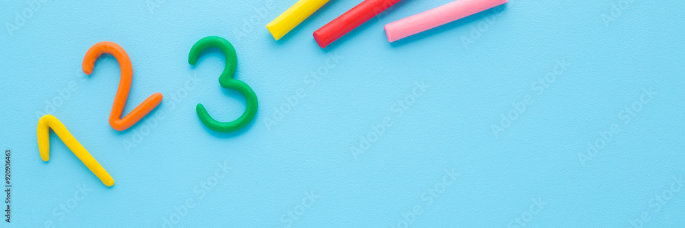 Colorful 123 numbers created from modeling clay on light blue table ...