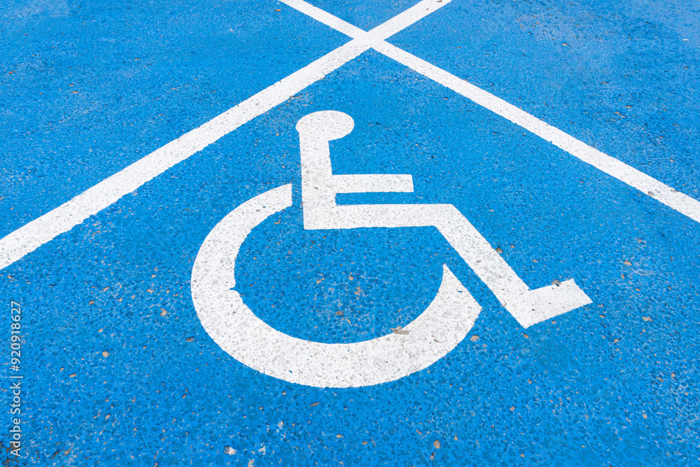 Handicapped parking sign on the ground. Wheelchair symbol. White and ...