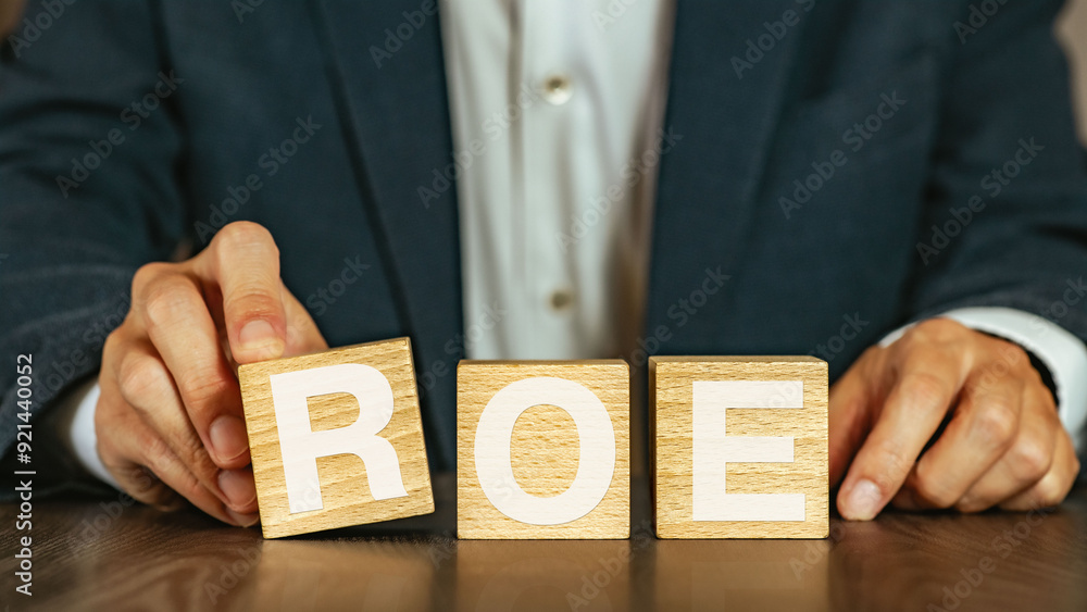 There is wood cube with the word ROE. It is an abbreviation for Return ...