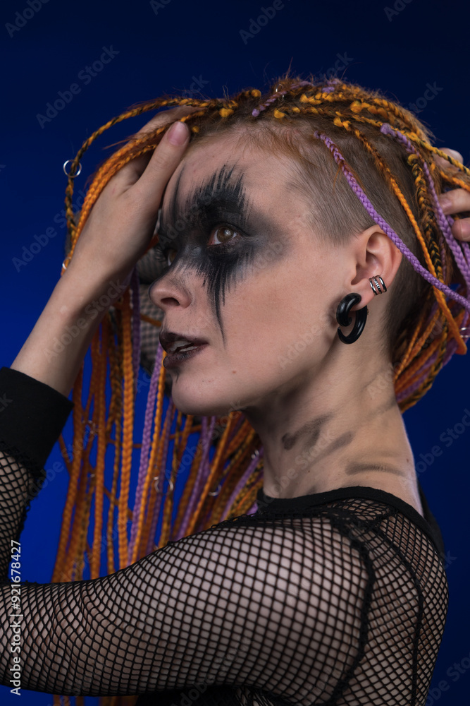 Striking adult female is adorned with an orange dreadlock hairstyle and ...