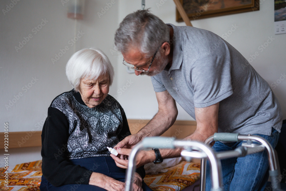 Man is helping an elderly woman with everyday tasks, helping with ...