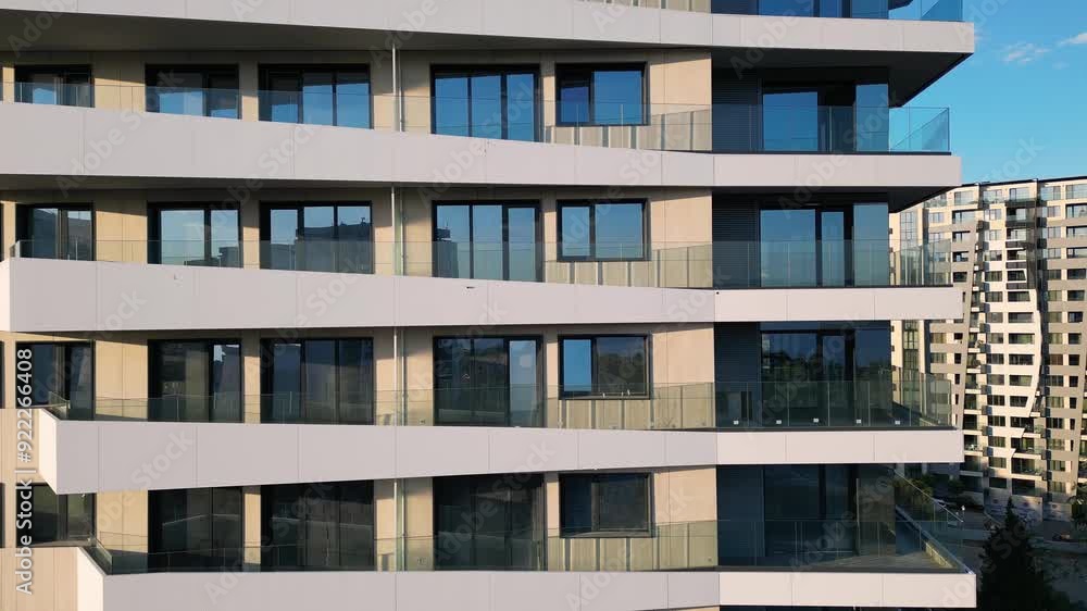 Drone flyby of a modern residential tower with unique, staggered ...