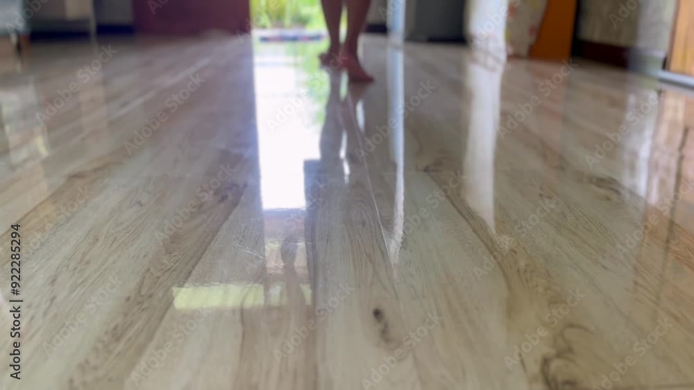 A close-up shot capturing the movement of bare feet against a backdrop ...