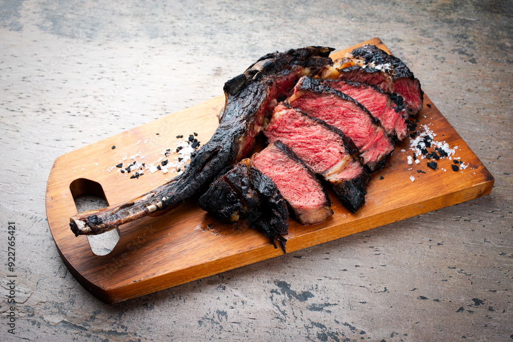 Traditional barbecue dry aged Kobe tomahawk steak with salt and black ...