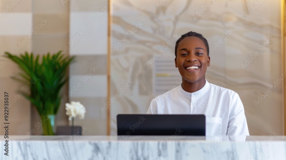 Friendly and professional hotel staff assisting guests at the check in ...