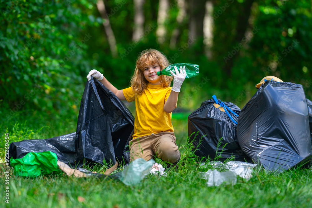 Child picking plastic trash for cleaning the nature. kid Clean up ...