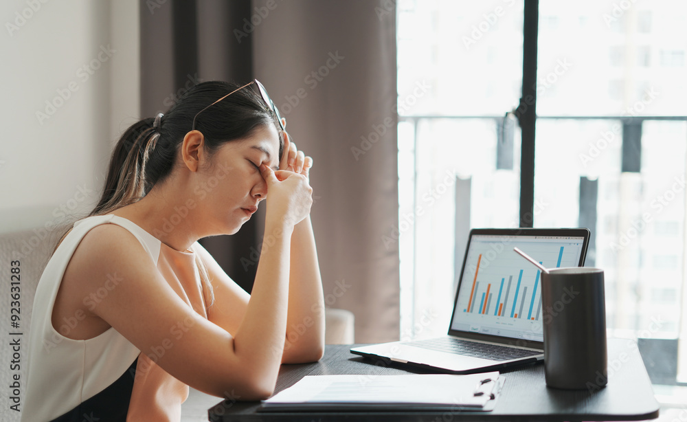 Young asian woman stressed while working on laptop, and suffering from ...