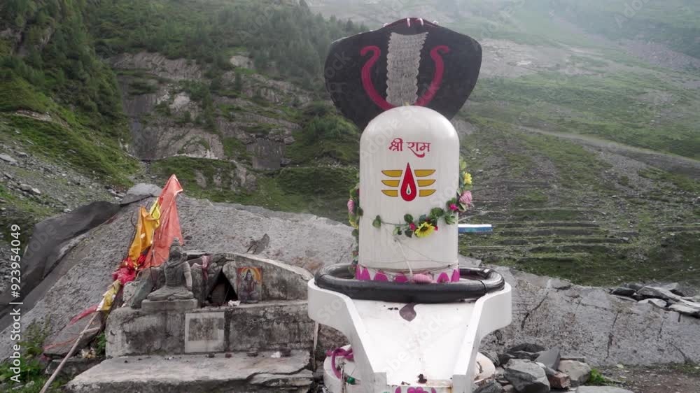 White sculpture of Shiva Lingam with the serpent god Shesh Naag on top ...
