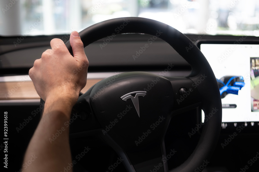 male hand on Driver's column, Behind steering wheel Tesla model Y ...