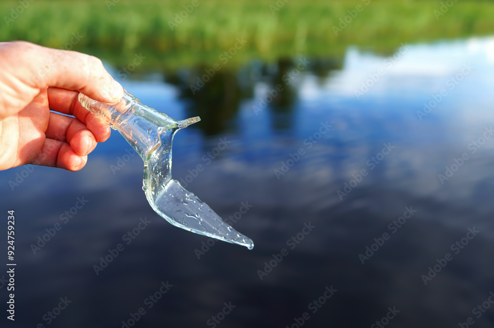 Marine debris. Broken glass bottle on riverbank. Broken Glass in The ...