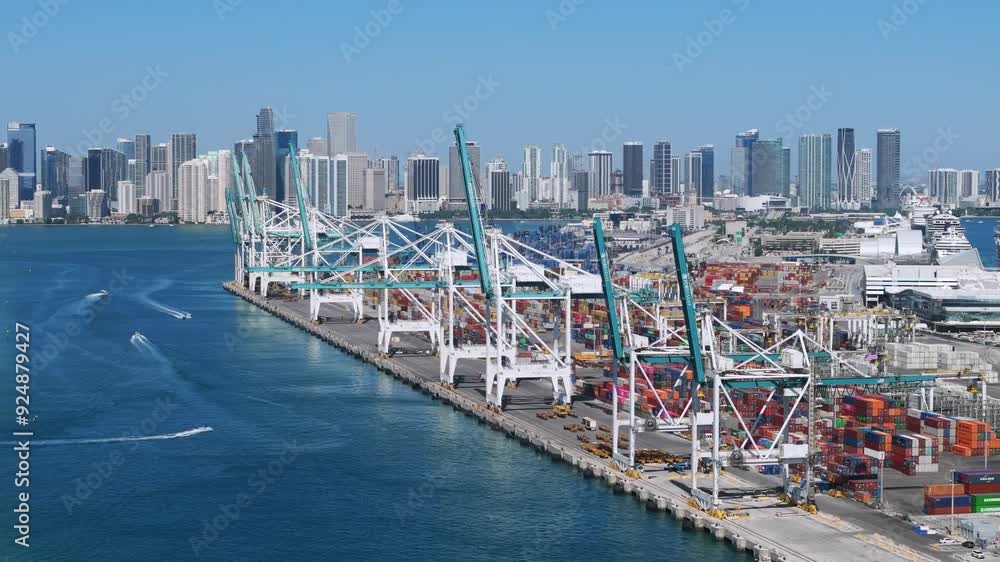 Port Miami with large white and green cranes, multiple shipping ...