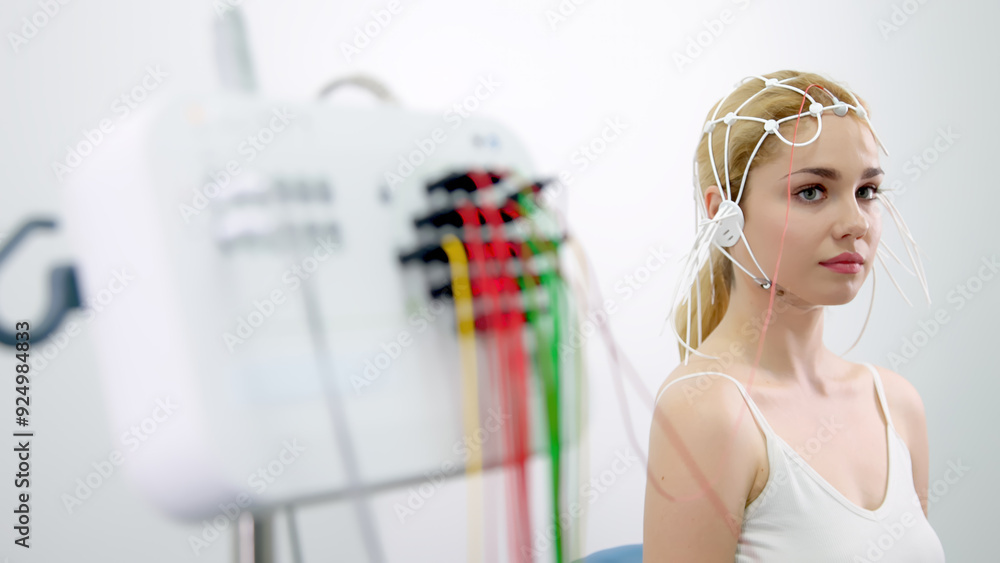 EEG sensors on the head of a young female patient for brain testing in ...
