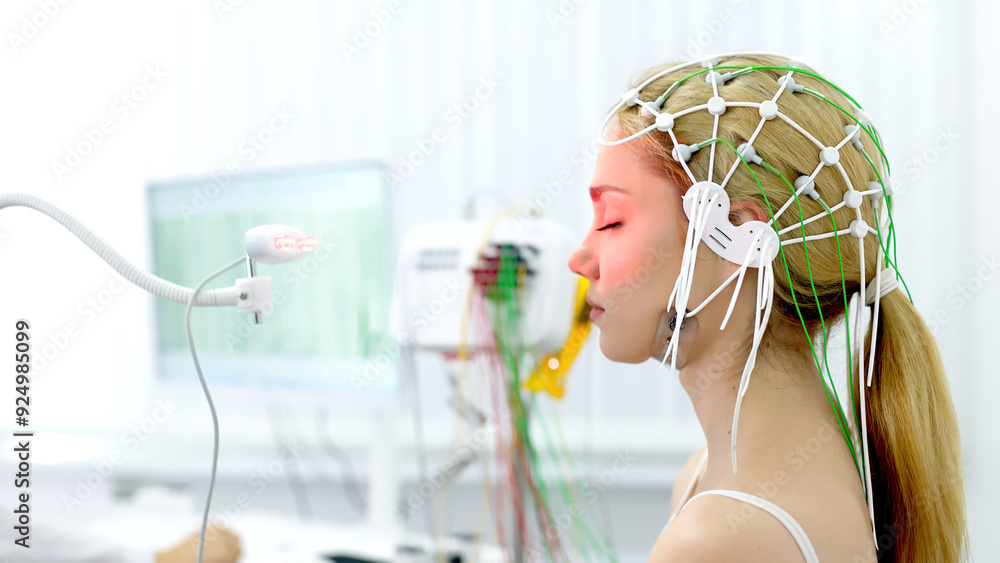 EEG sensors on the head of a young female patient for brain testing in ...