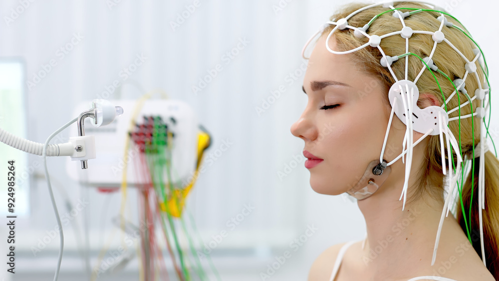 EEG sensors on the head of a young female patient for brain testing in ...