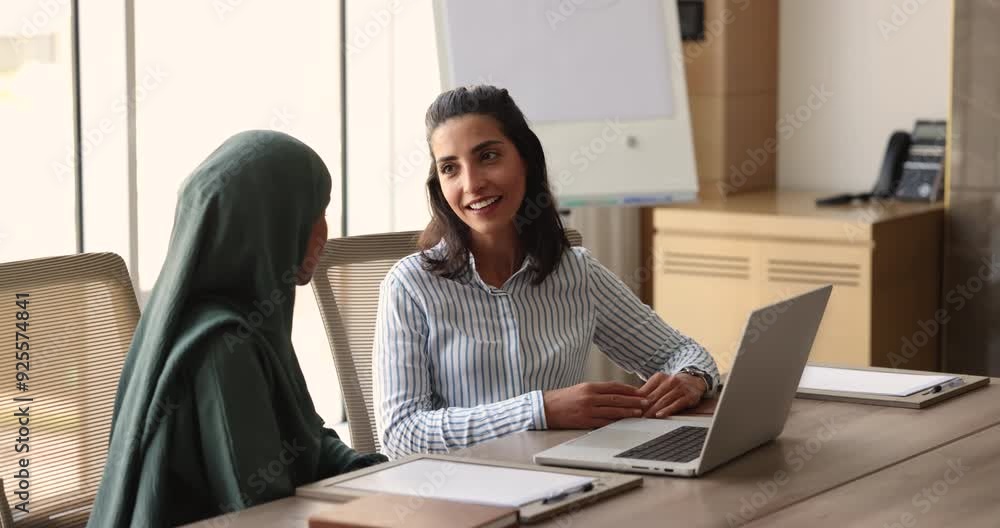 Positive Latin business professional woman and young Arabic female ...