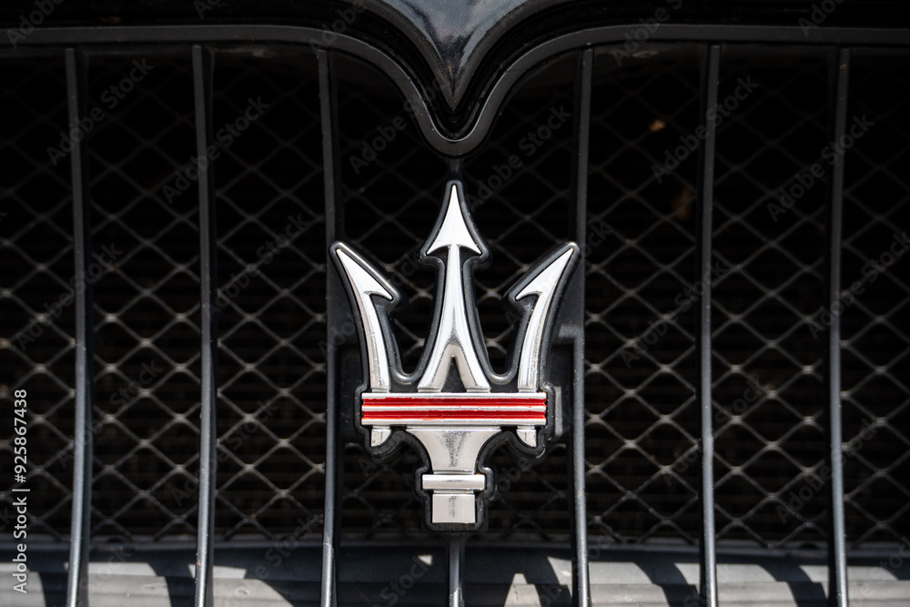 Maserati logo sign on a front grille of a car. Italian luxury vehicle ...