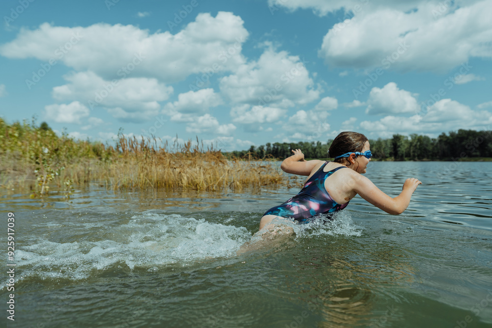 Playful child enjoying a summer day at the lake, running through the ...