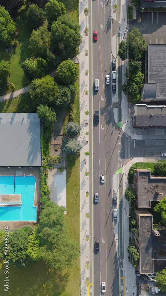 Aerial tracking above a two-way urban street with a designated bike ...
